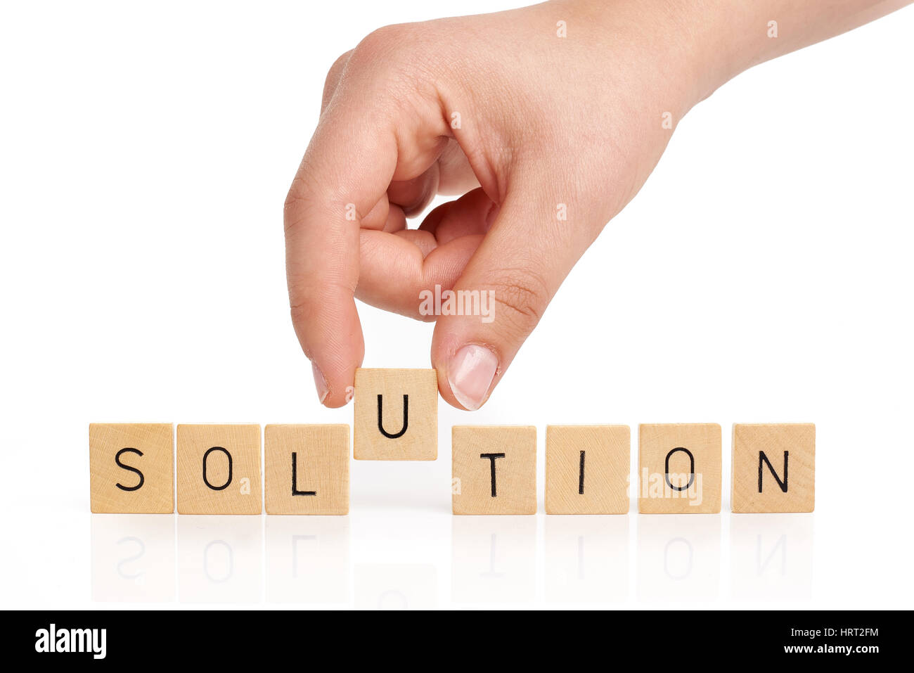 Hand is building the word solution on white background Stock Photo - Alamy