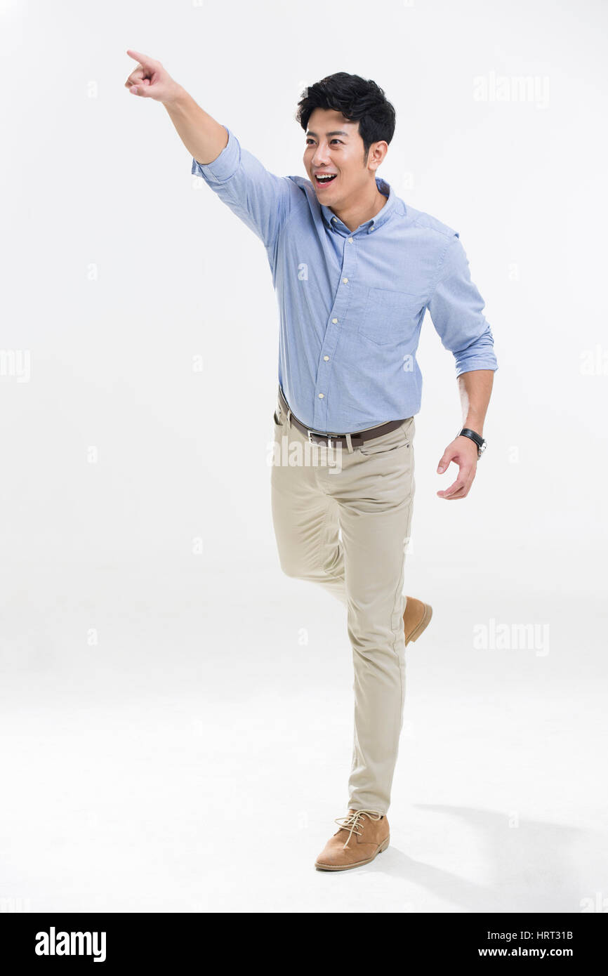 Cheerful young man pointing Stock Photo - Alamy