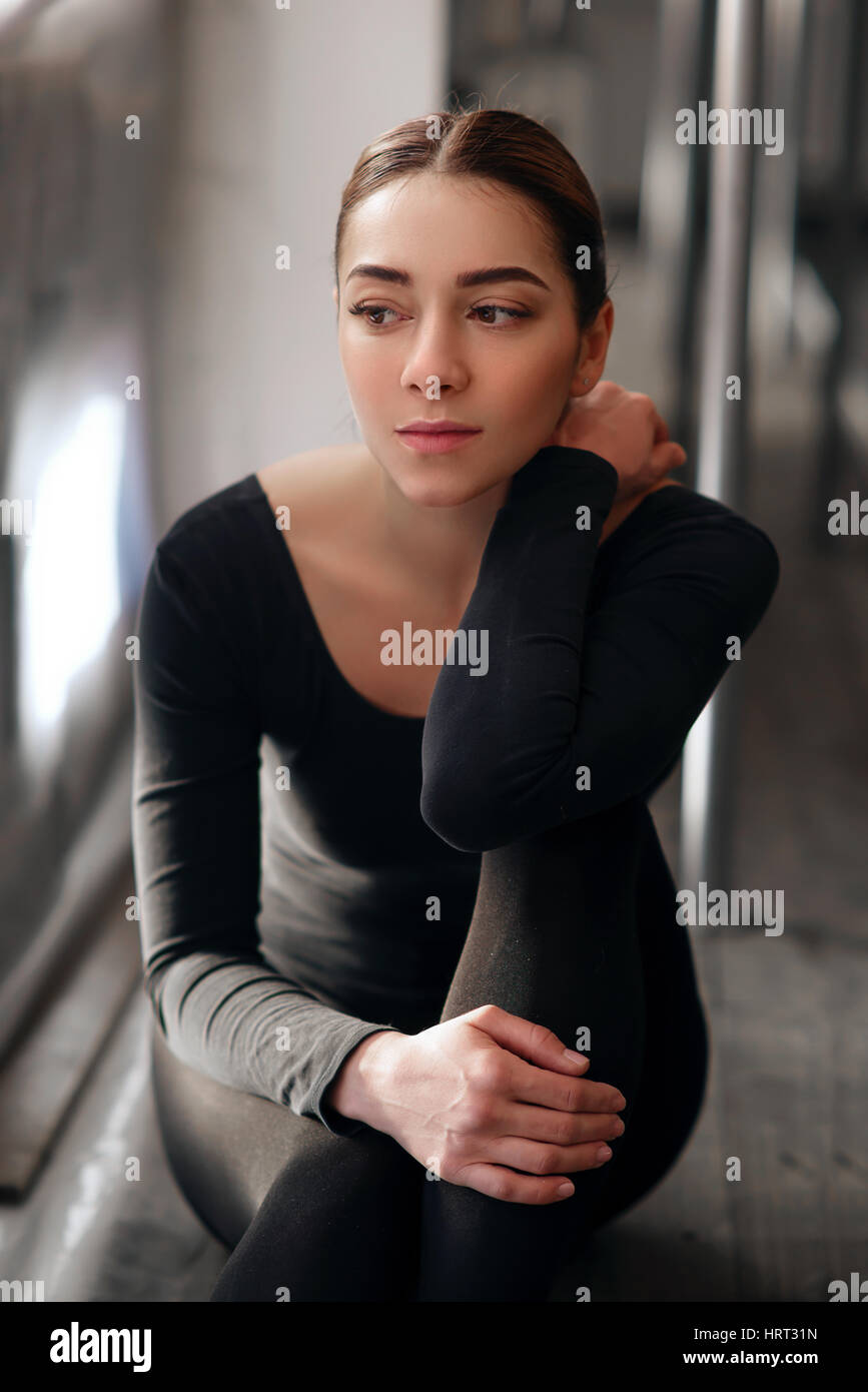 Female ballet dancer sitting on the floor after rehearsal against ...