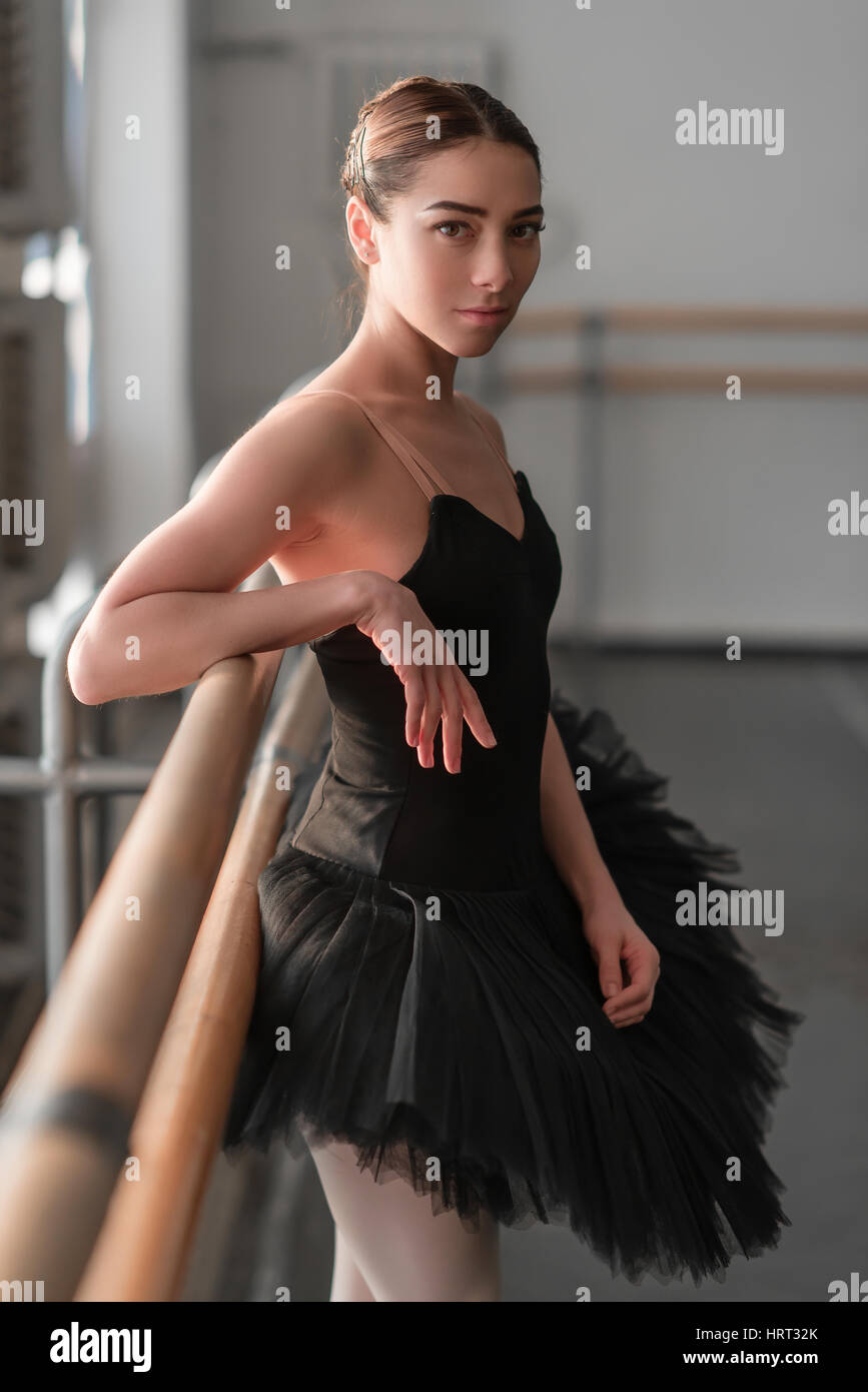 Female ballet dancer resting in class with barre after rehearsal Stock ...