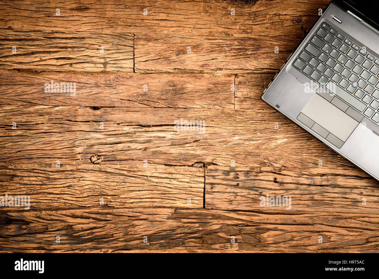 Laptop on a old table top view Stock Photo - Alamy