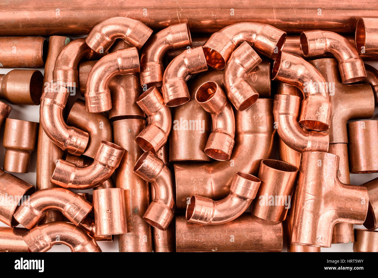 Copper elbow,Tee way copper pipe, industrial background Stock Photo - Alamy