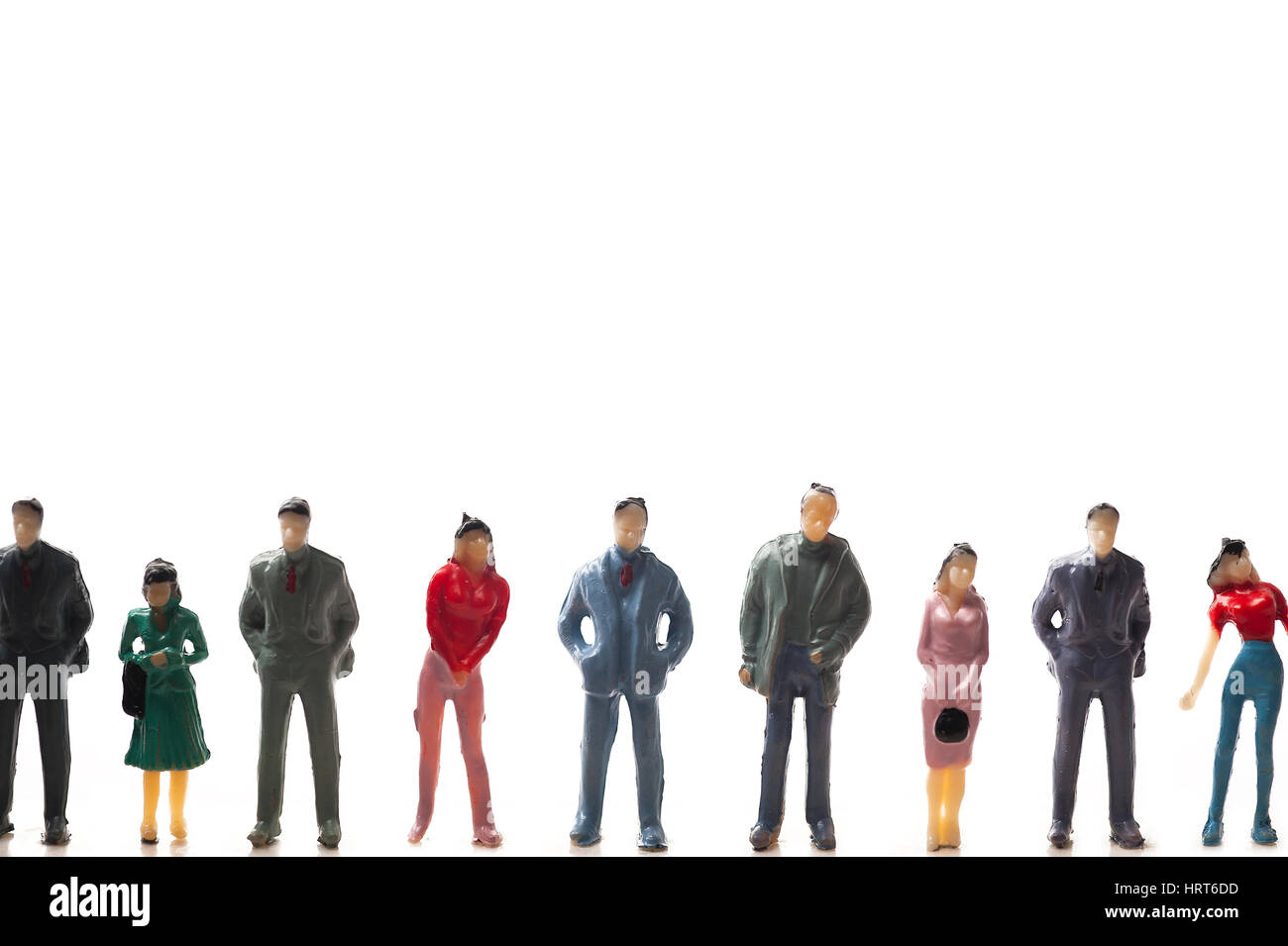 Miniature figurines of people in a line against white background Stock ...