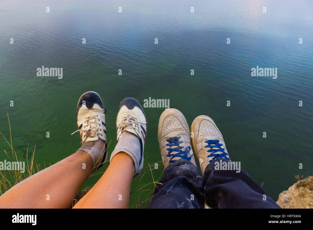 Young man hanging edge cliff hi-res stock photography and images - Alamy