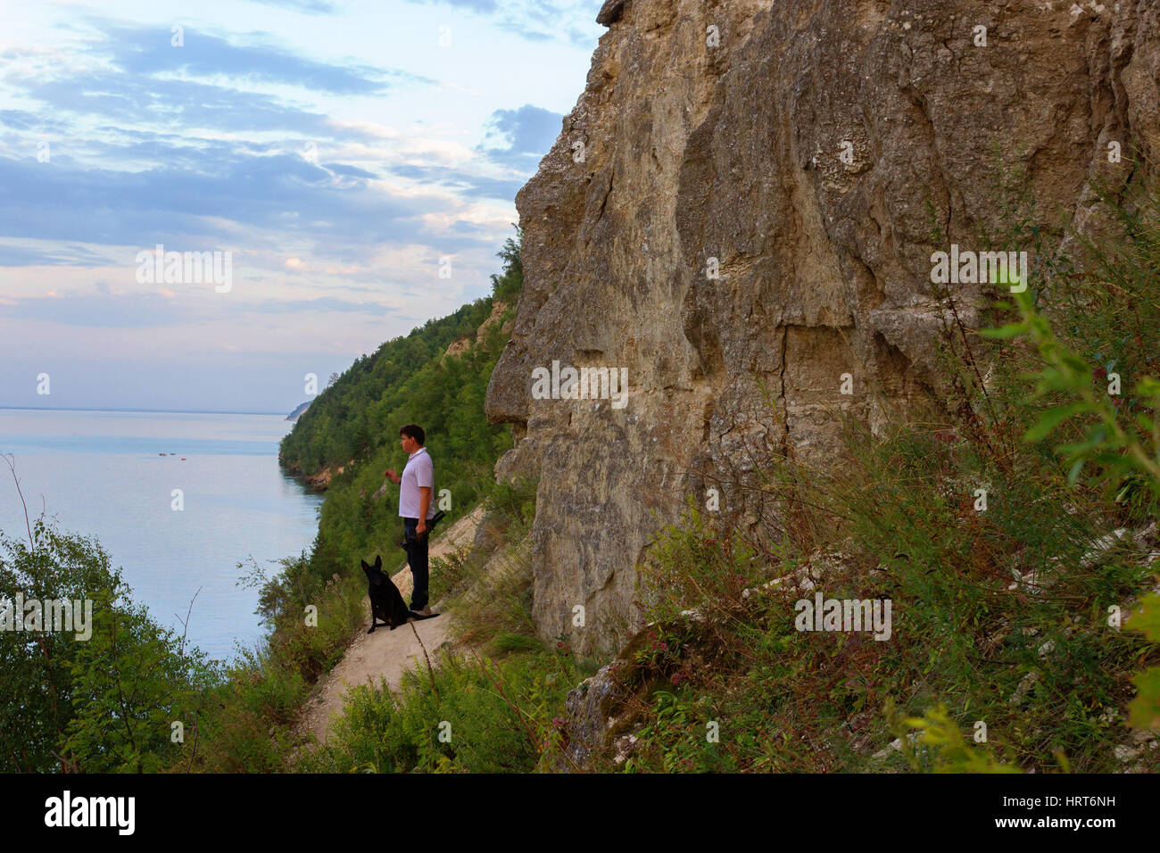 Men and dog on rocky road. trees Stock Photo - Alamy