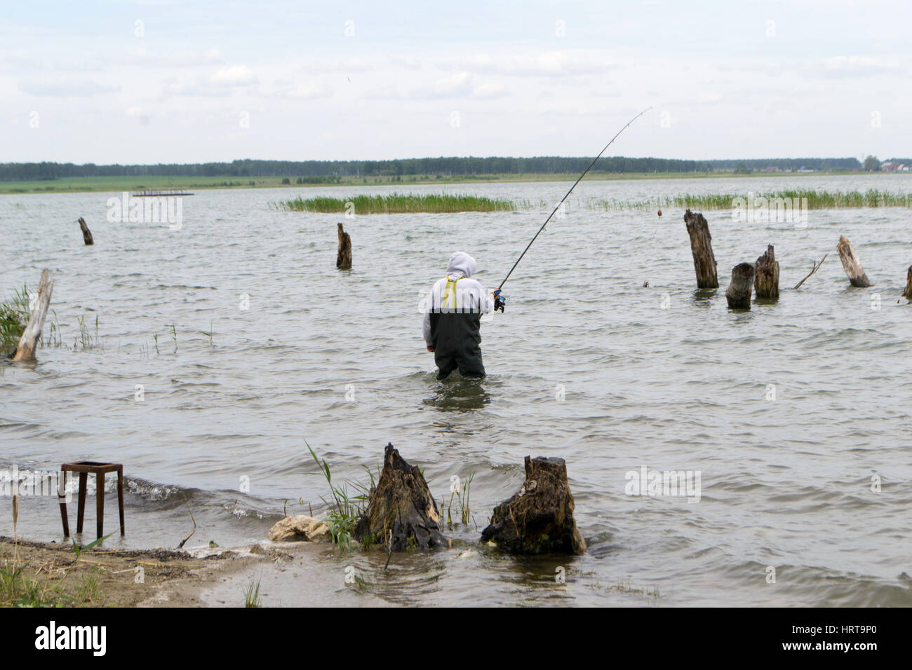 a fisherman catches fish in the lake Stock Photo - Alamy