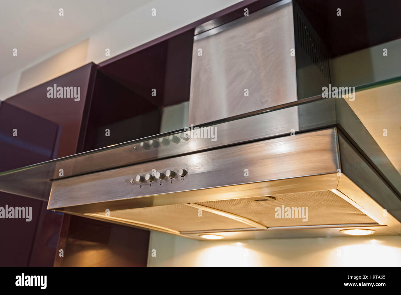 Closeup detail of buttons on metal cooker hood extractor fan with ...