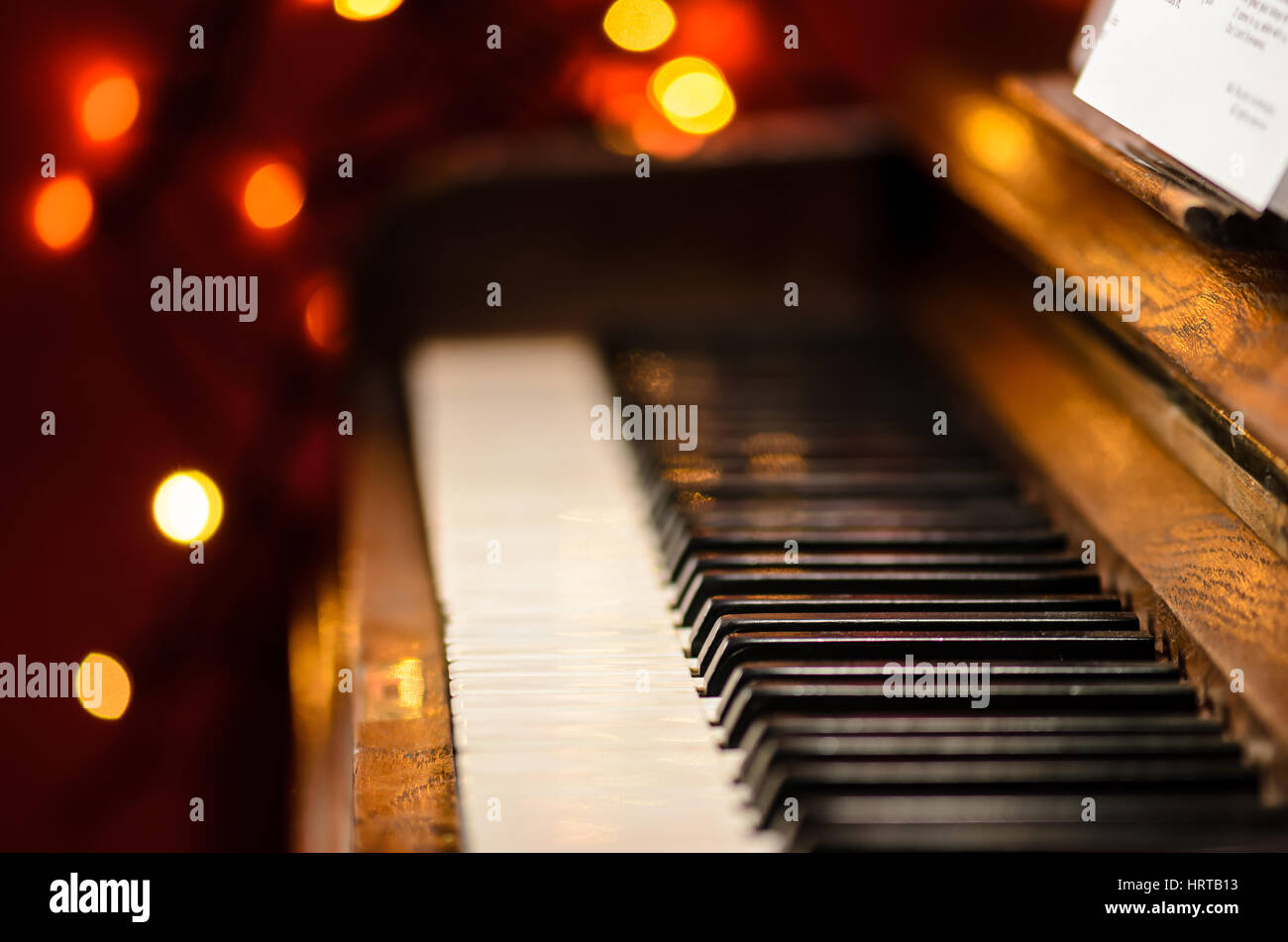 Piano with lights in background Stock Photo - Alamy