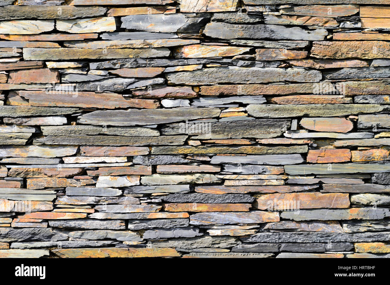 Schist stones on a house piled to a wall Stock Photo - Alamy