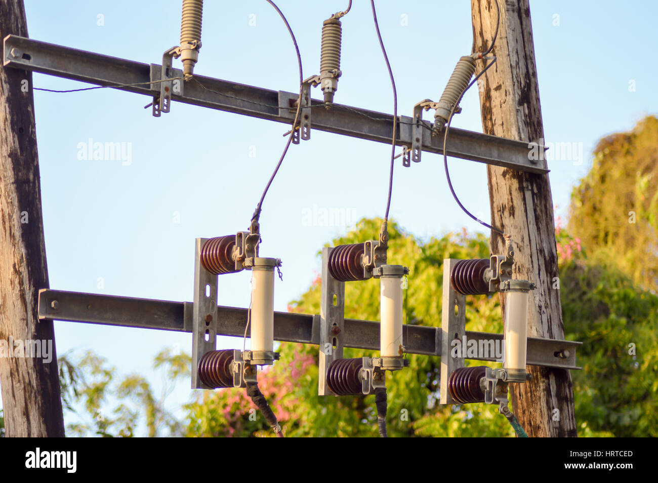 Cartridge fuses attach to a wooden pylon with insulators Stock Photo ...