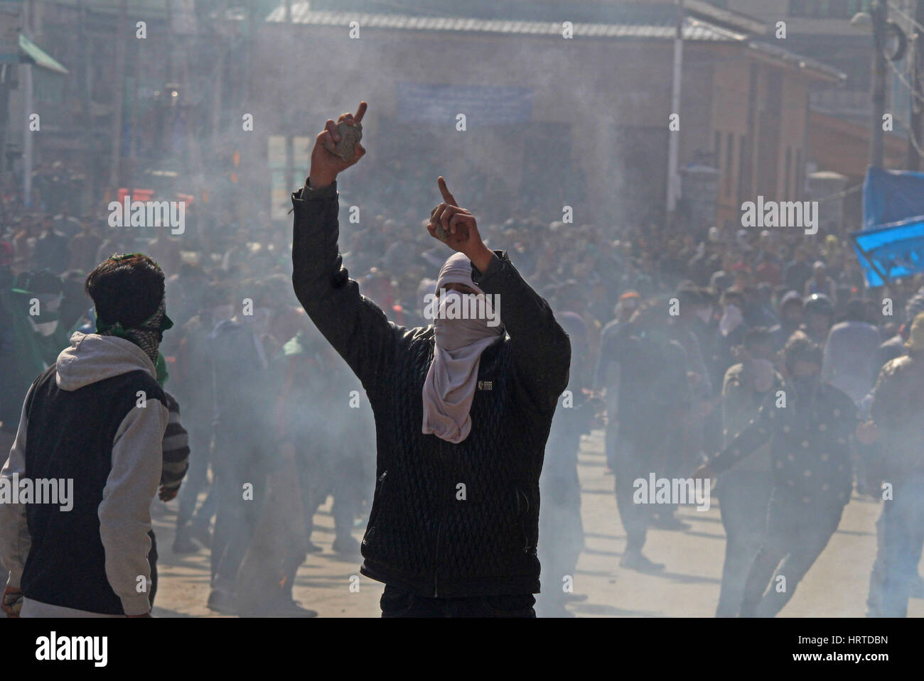 Srinagar, Kashmir. 03rd Mar, 2017. Masked youth holding stones in hands ...
