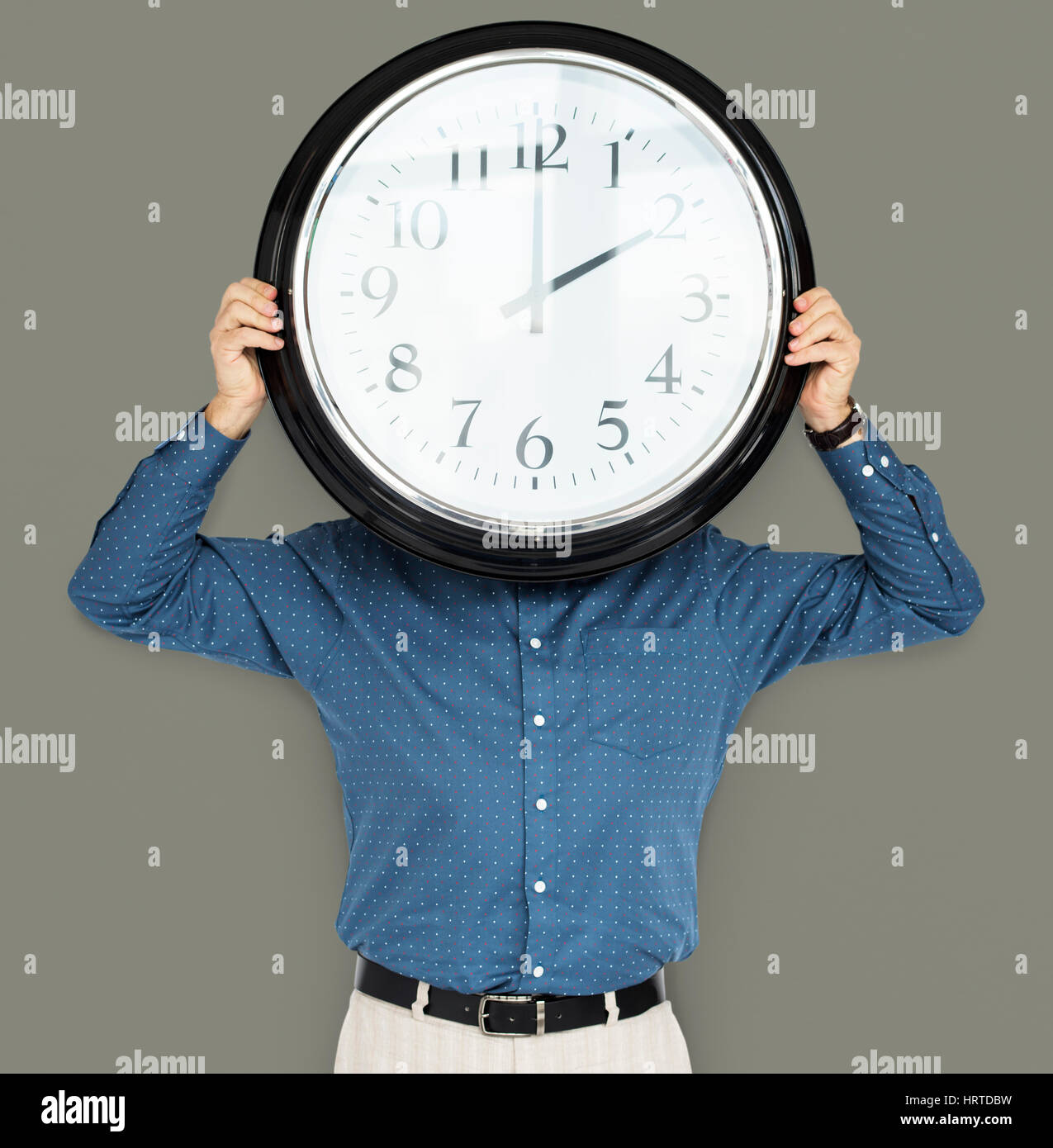 Man Holding Clock Covering Face Stock Photo - Alamy