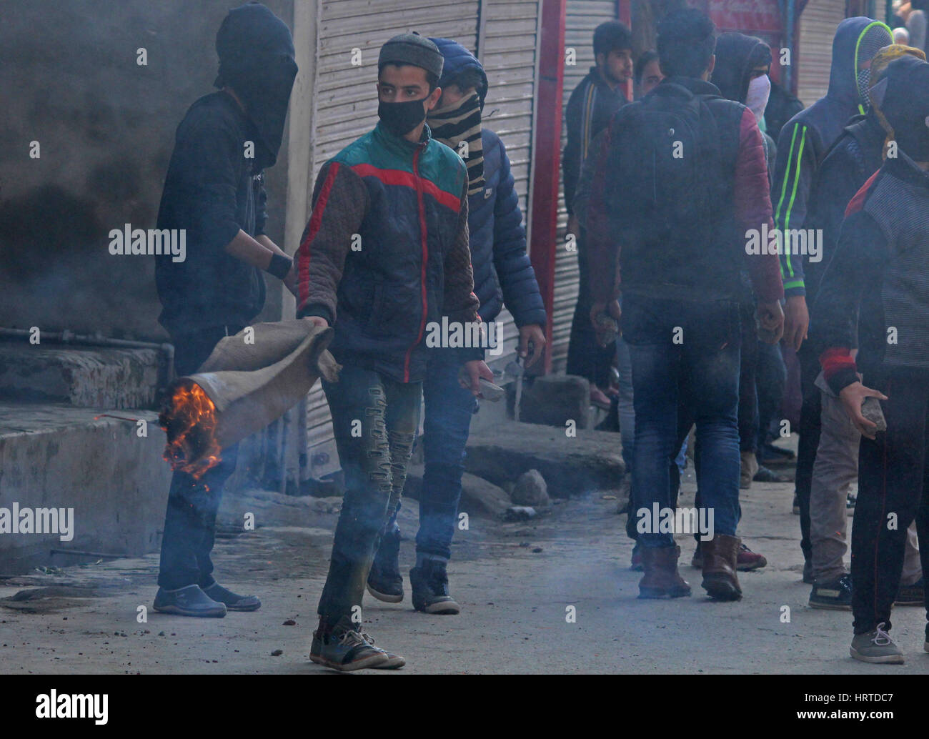 Srinagar, Kashmir. 03rd Mar, 2017. A youth carrying the burning bag in ...