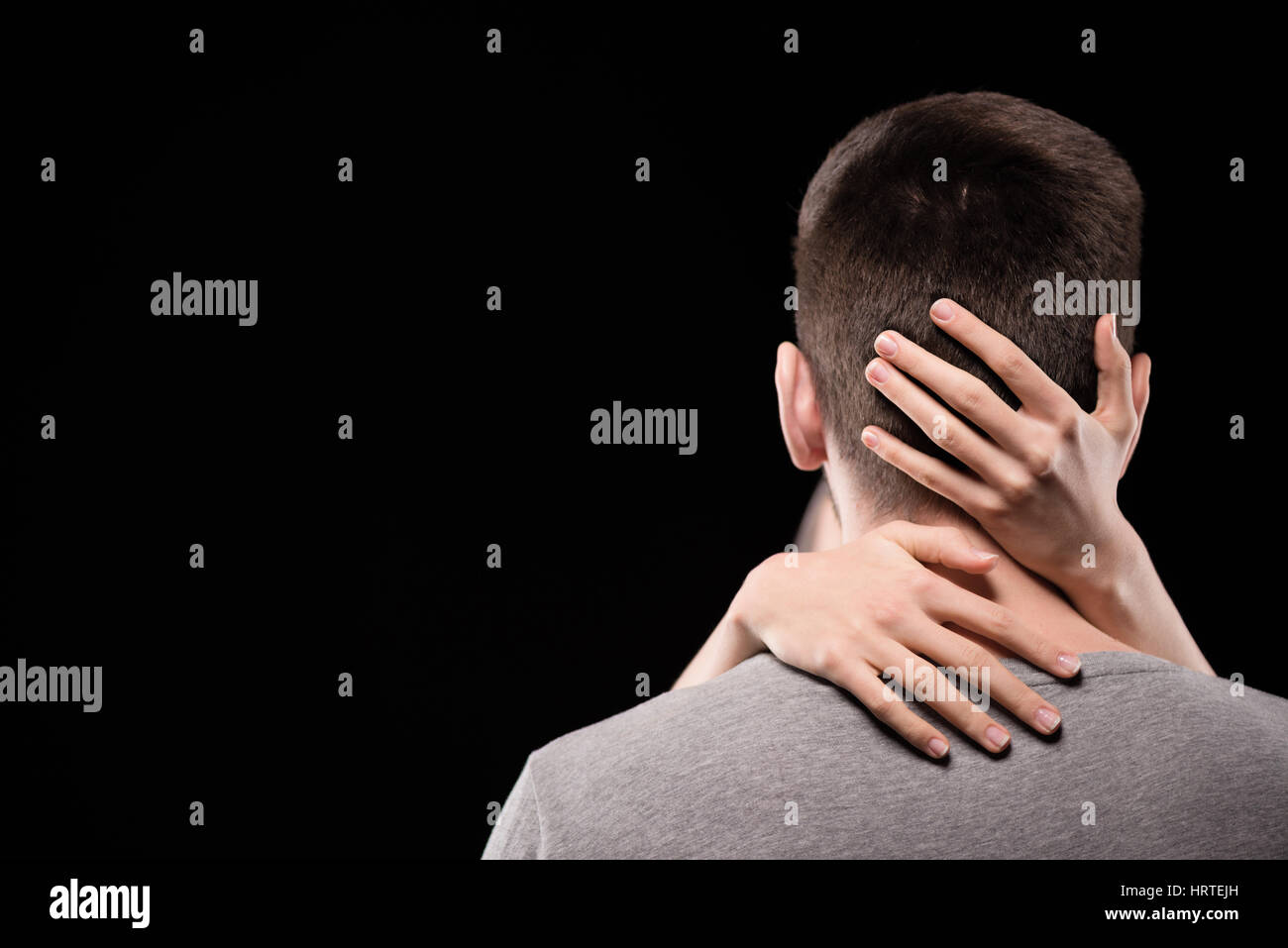 back view of couple in love hugging on black Stock Photo - Alamy