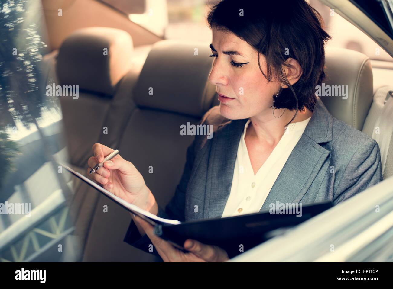 Businesswoman Busy Working Car Inside Stock Photo - Alamy