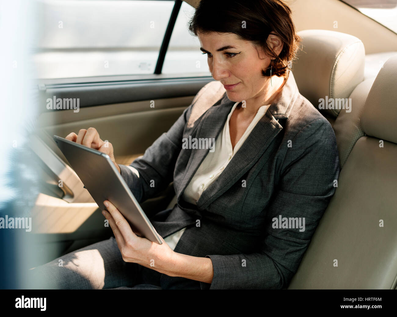 Female passenger using tablet hi-res stock photography and images - Alamy