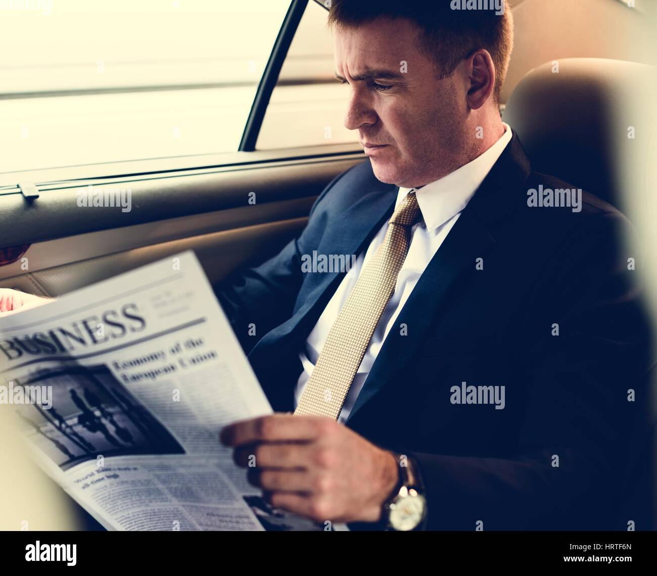 Businessman Reading Newspaper Car Inside Stock Photo - Alamy