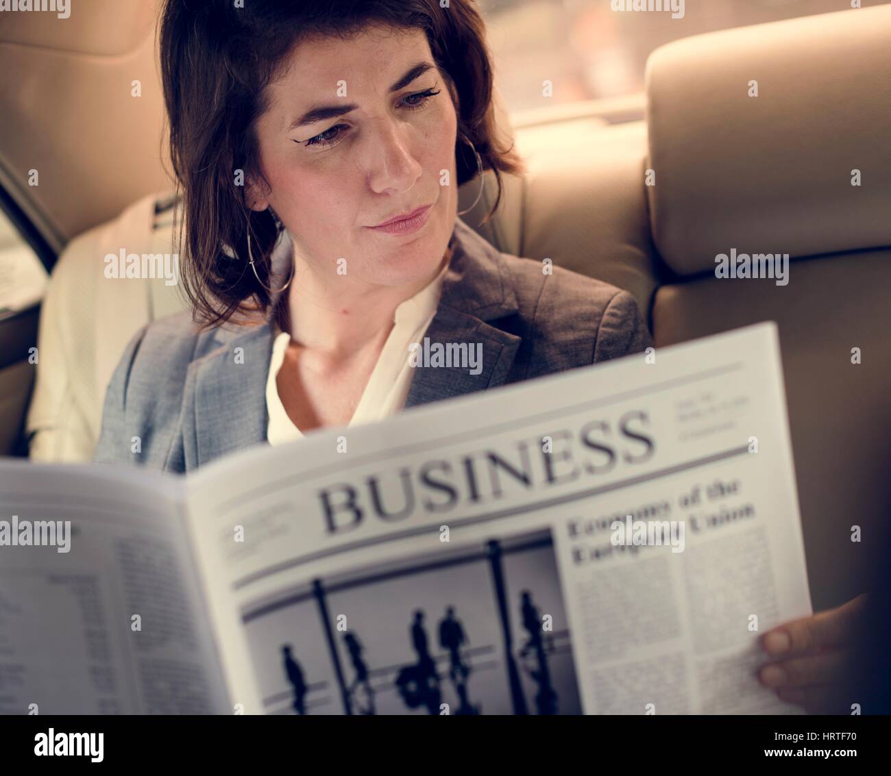 Businesswoman Reading Newspaper Car Inside Stock Photo - Alamy