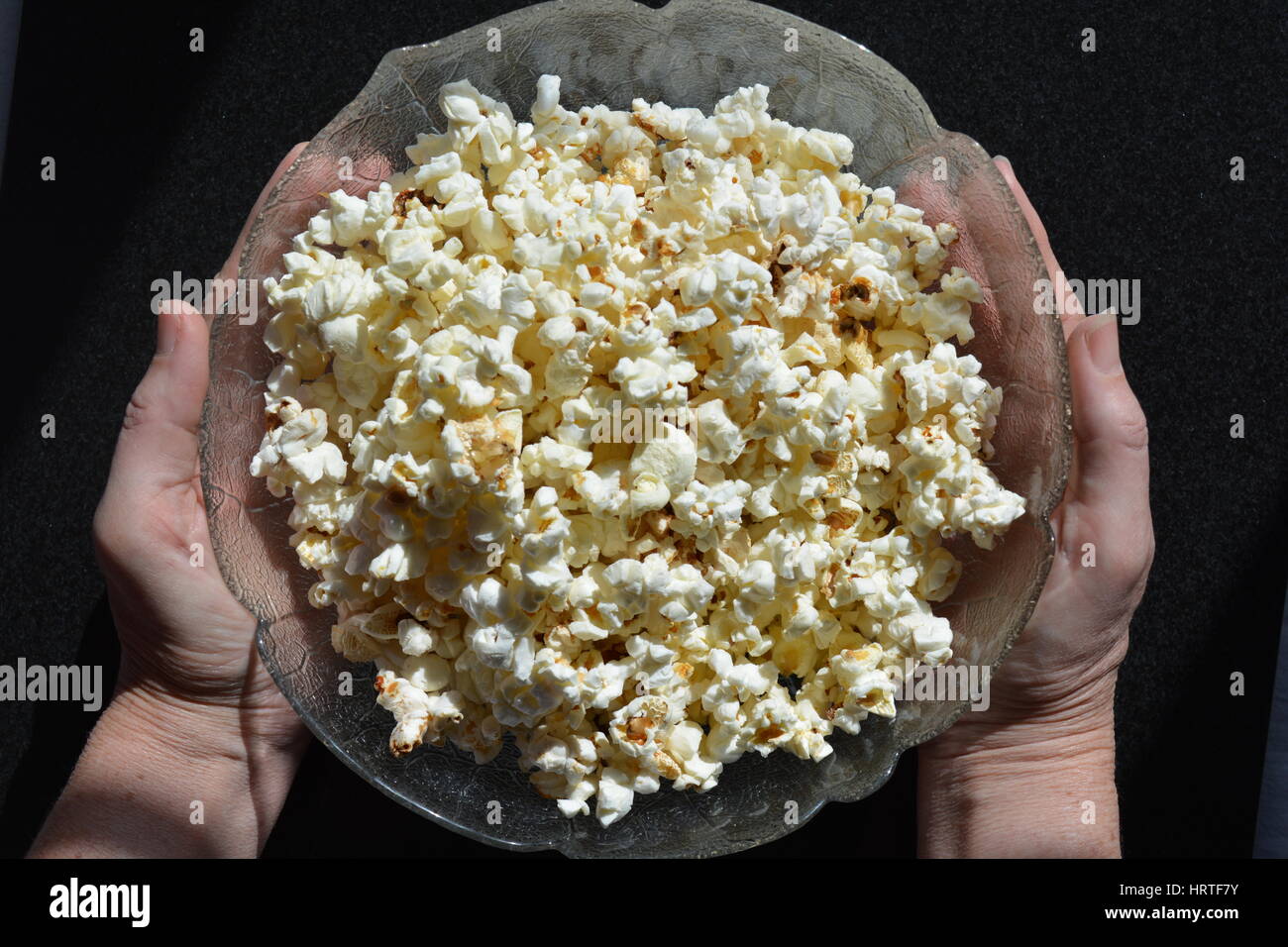 Person eating popcorn, close up Stock Photo - Alamy