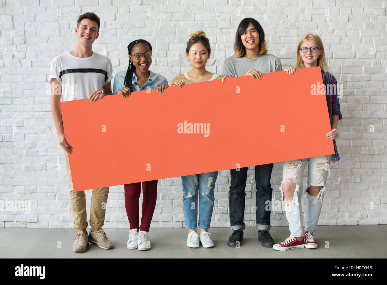 Group of Friends Holding Blank Banner Stock Photo - Alamy