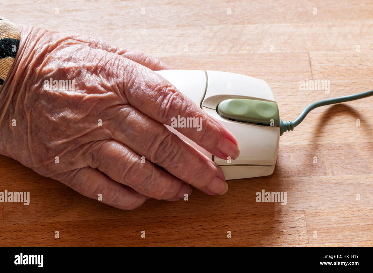 Hand of eldeerly senior woman using computer mouse. Senior using ...