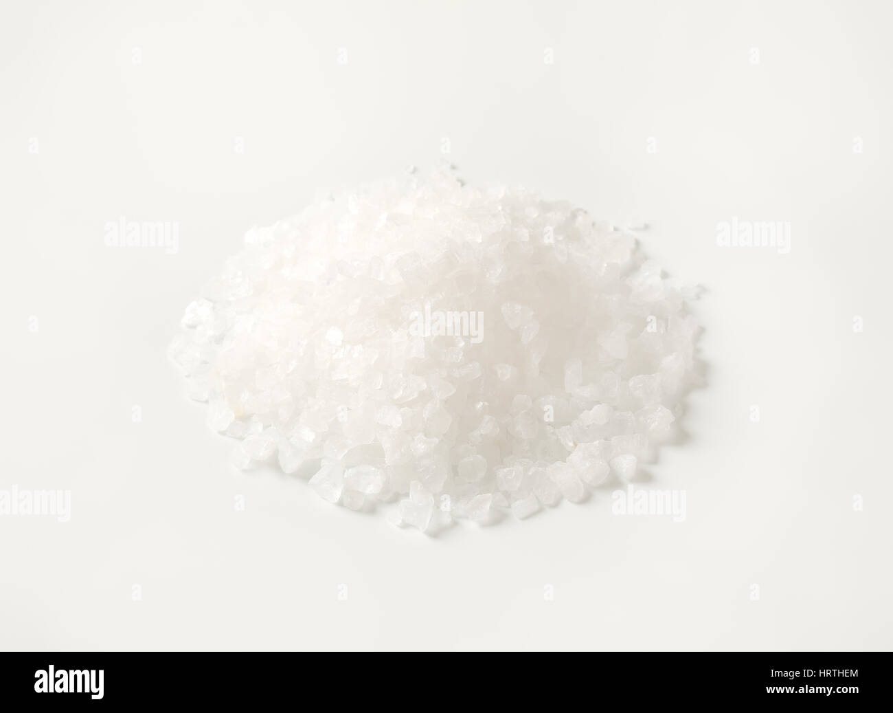 pile of coarse grained salt on white background Stock Photo - Alamy