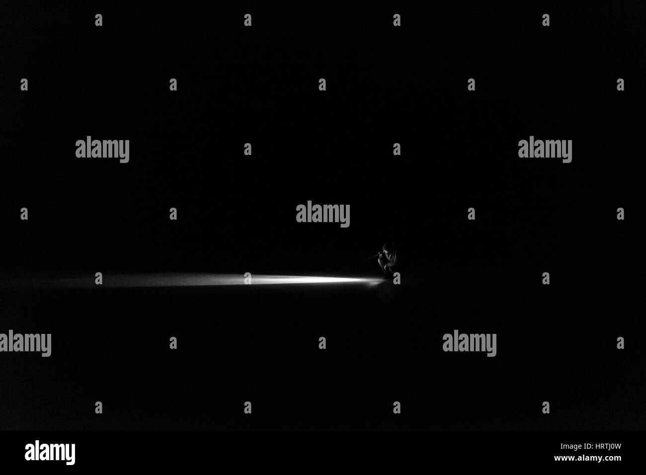 Human with flashlight standing on a ice lake at night. Sweden ...