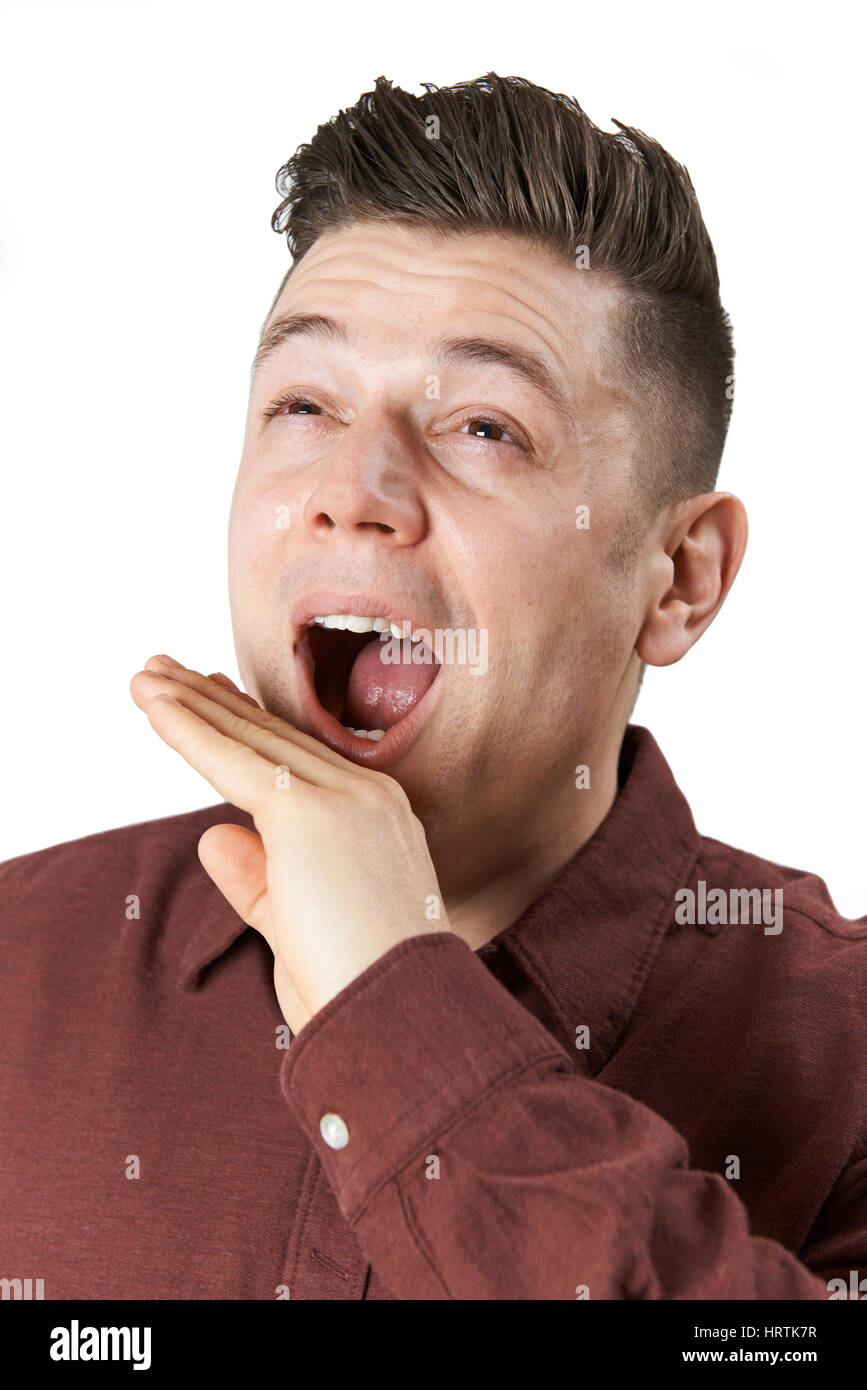 Studio Shot Of Man Yawning Stock Photo - Alamy