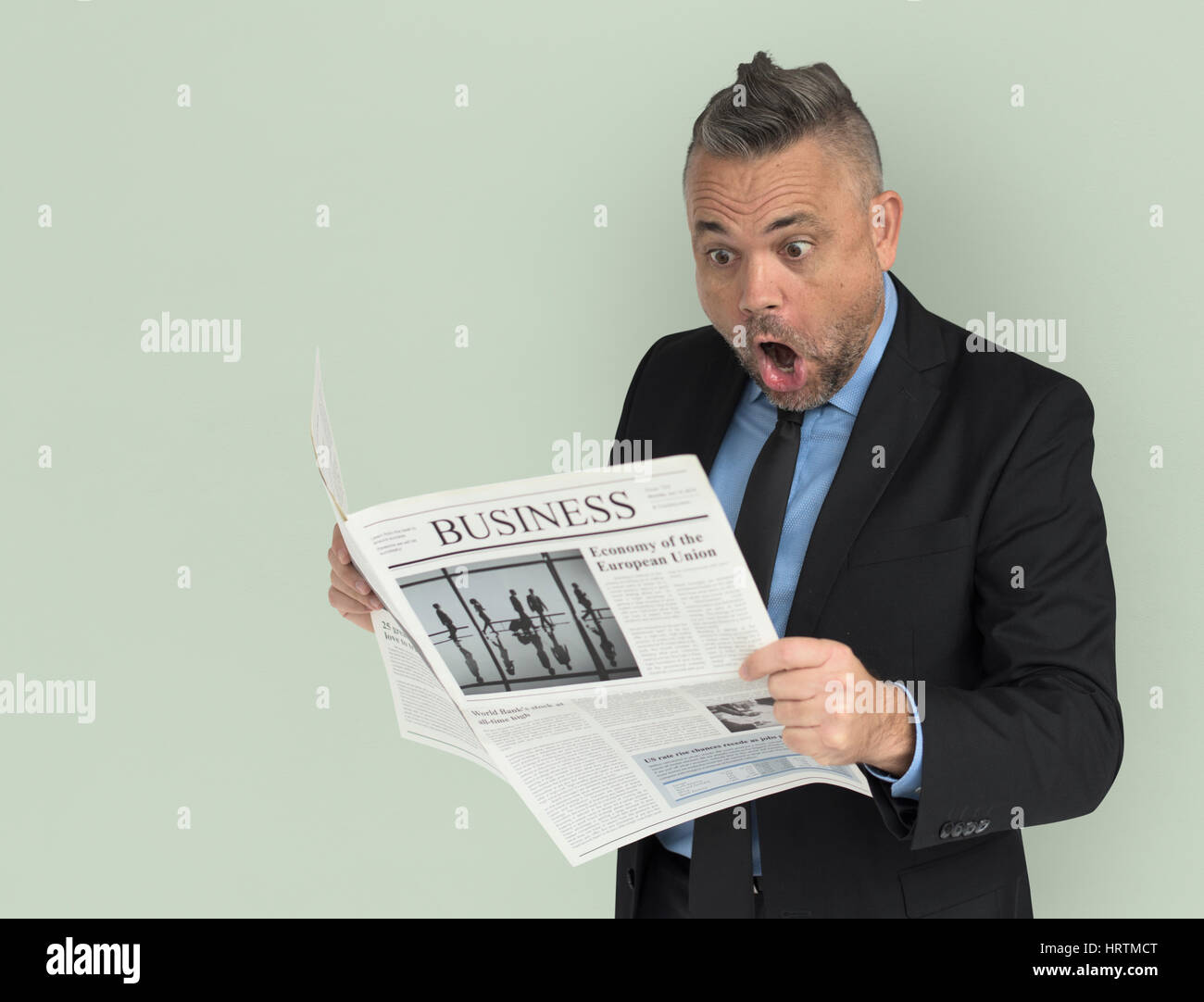 Caucasian Business Man Reading Newspaper Shocked Stock Photo - Alamy