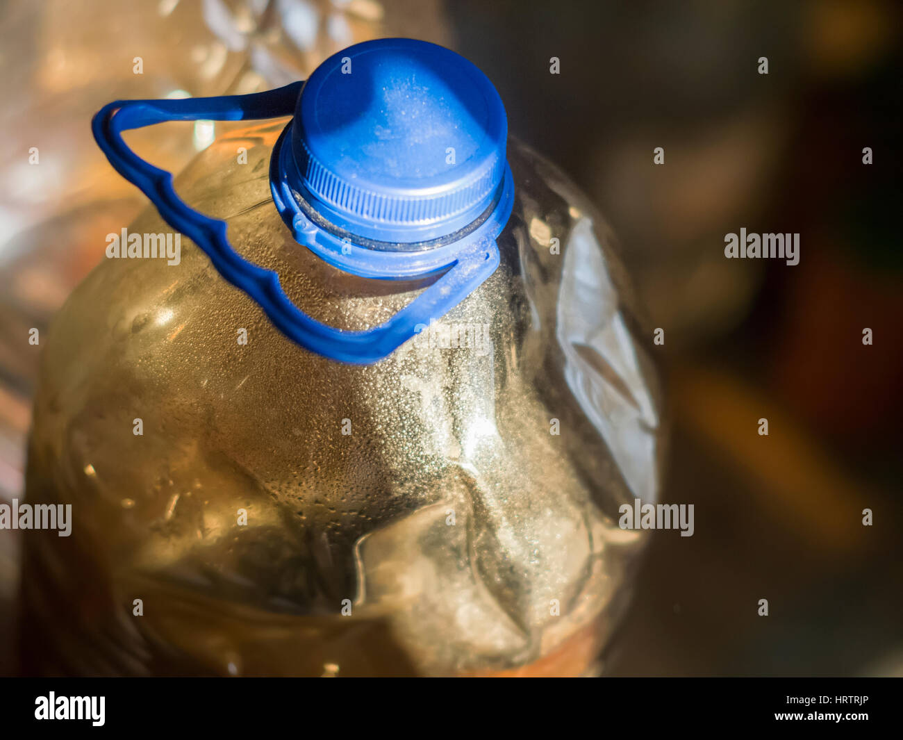 The dented plastic bottle with the water Stock Photo - Alamy