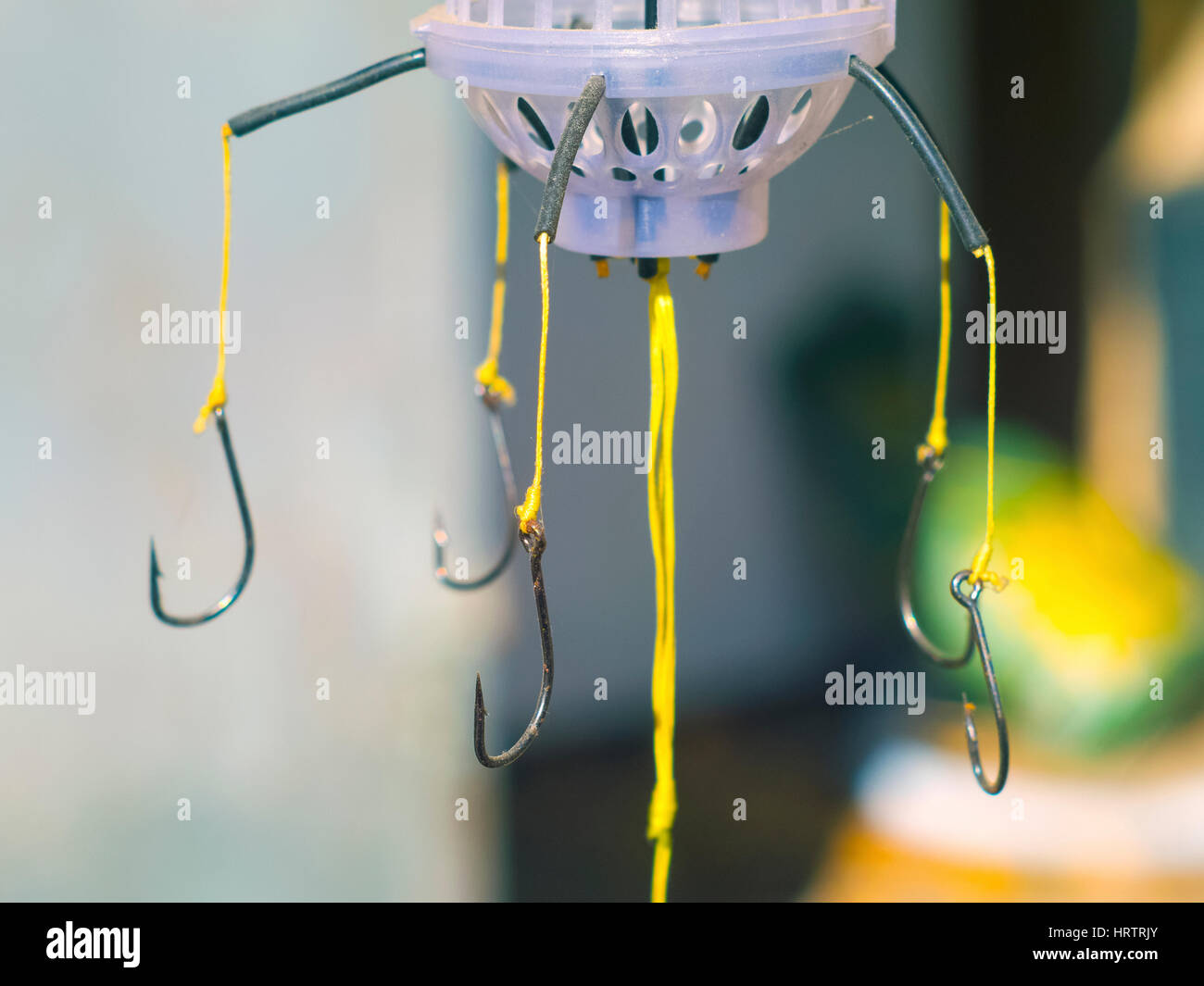 the fishing hooks on a fishing line with a trough Stock Photo - Alamy