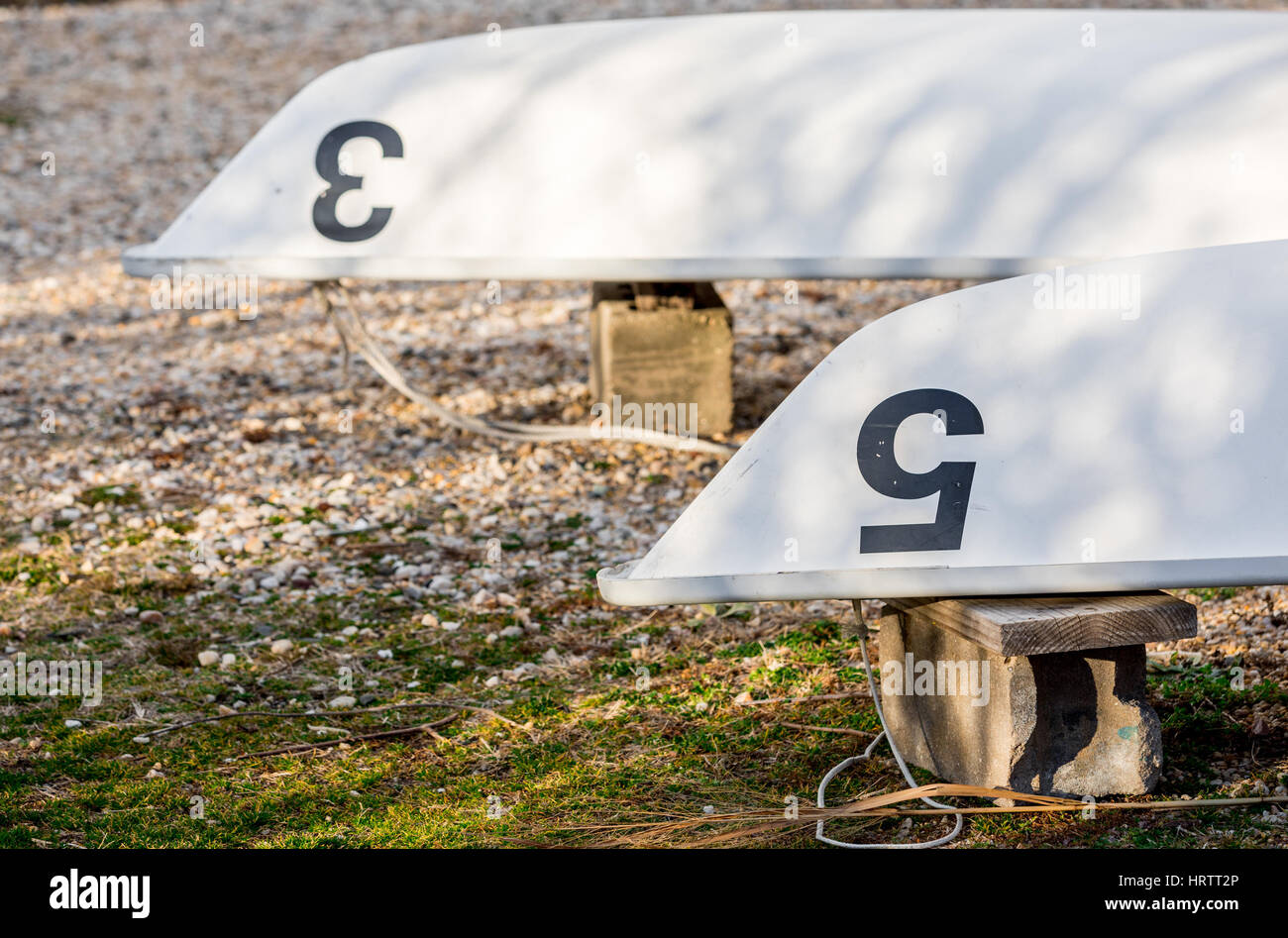 the bow of two small white boats, both with numbers 3 and 5 Stock Photo ...