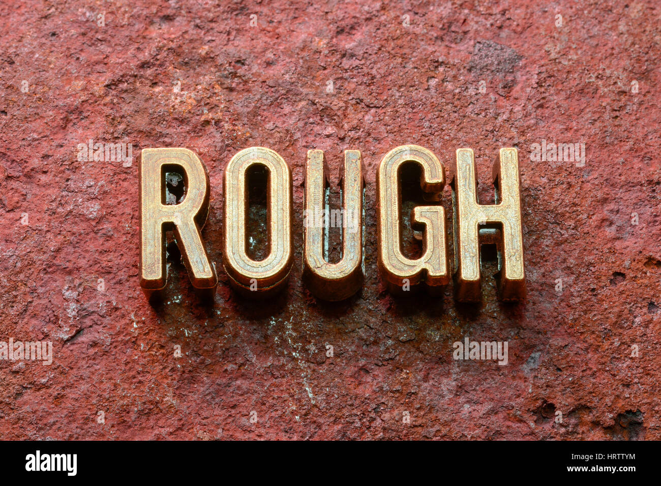 Rough Word Made From Metallic Letters On Red Rusty Surface Stock Photo rough-word-made-from-metallic-letters-on-red-rusty-surface-stock-photo