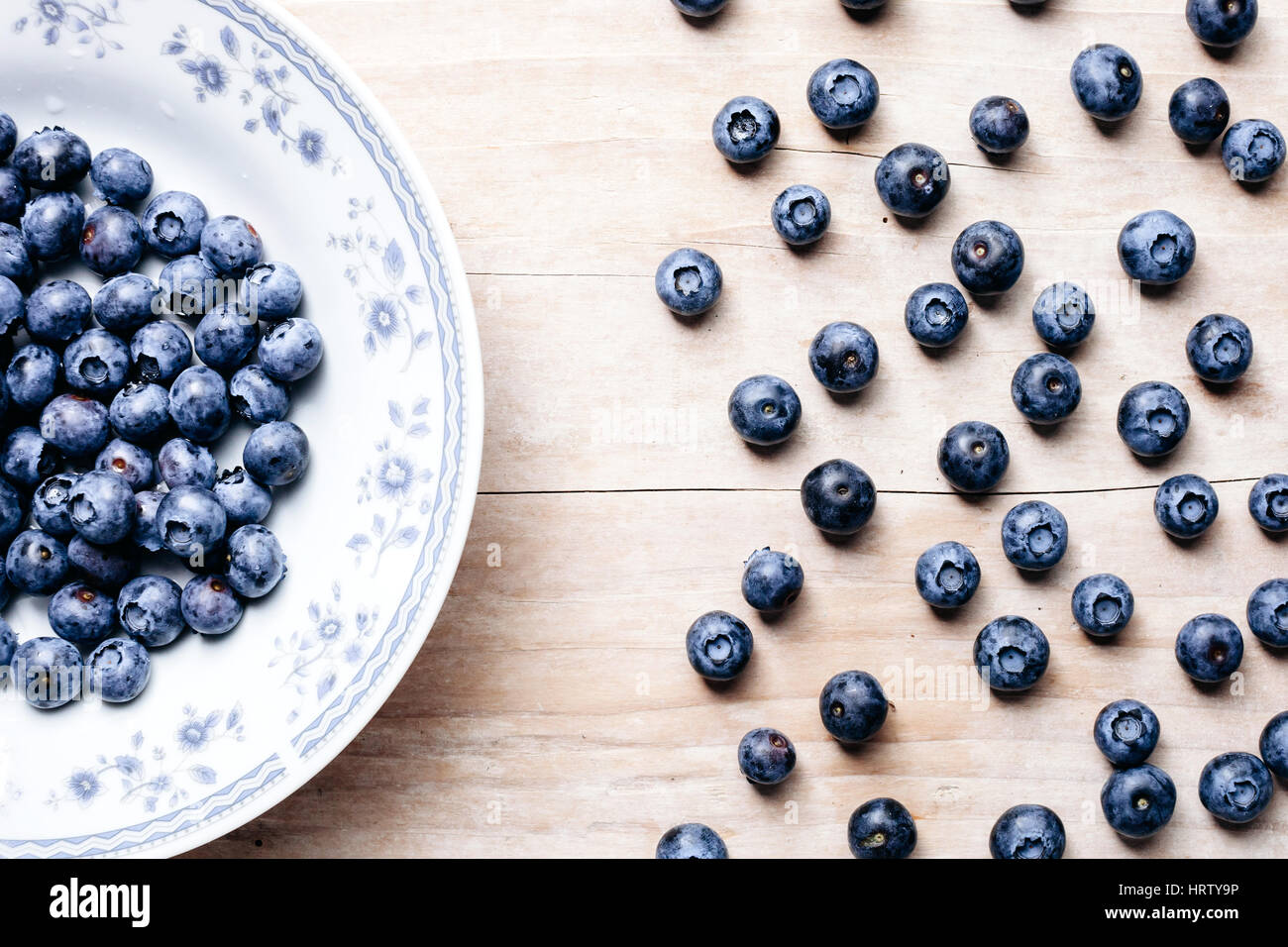 fresh juicy blueberry on plate and wood table top view Stock Photo - Alamy