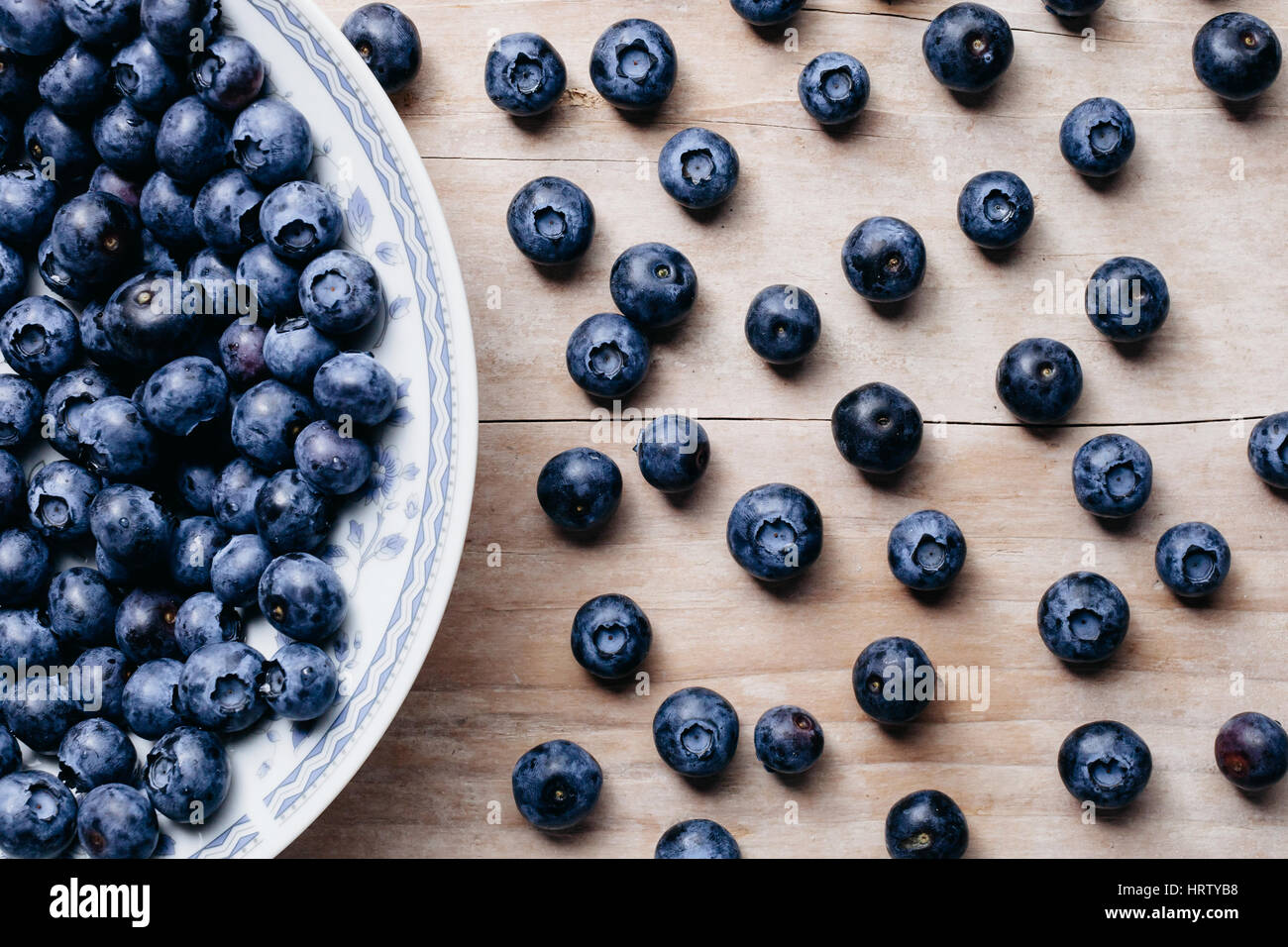 fresh juicy blueberry on plate and wood table top view Stock Photo - Alamy