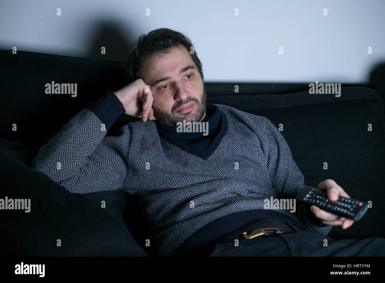 Man lying on sofa watching tv hi-res stock photography and images - Alamy