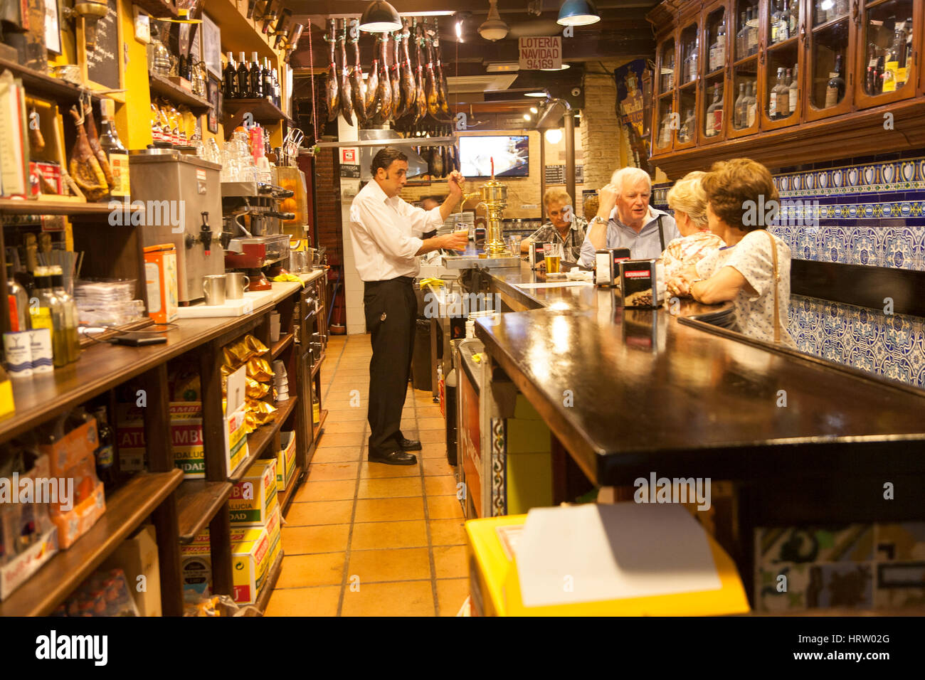 People inside a traditional cafe bar in Seville, Spain Stock Photo - Alamy