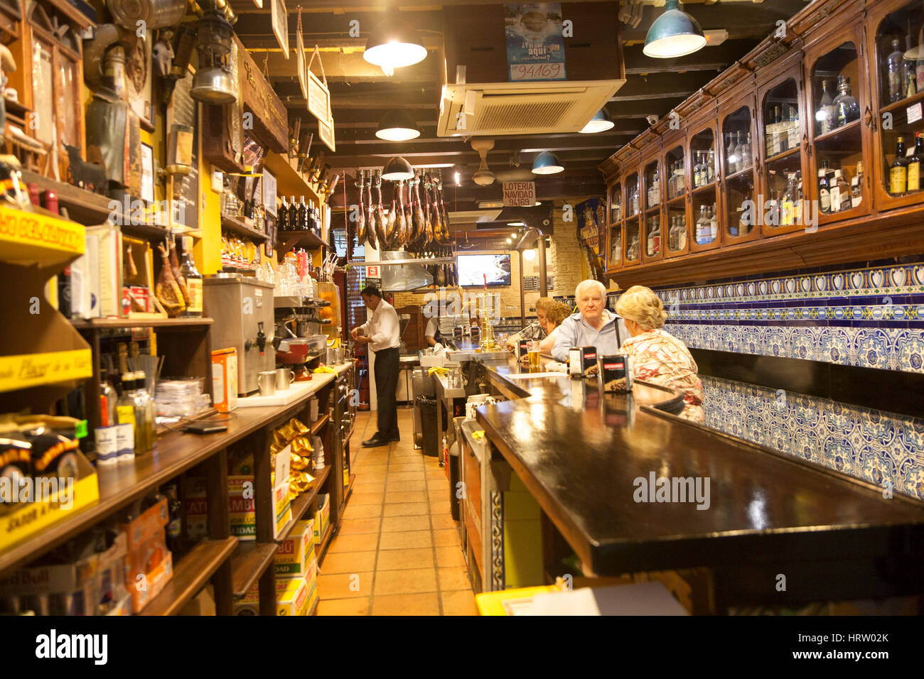 People inside a traditional cafe bar in Seville, Spain Stock Photo - Alamy