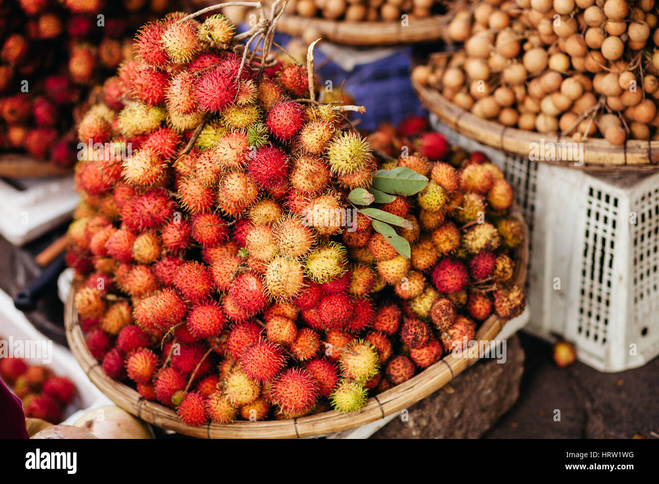 rambutan ripe at tropical market with longan background Stock Photo - Alamy