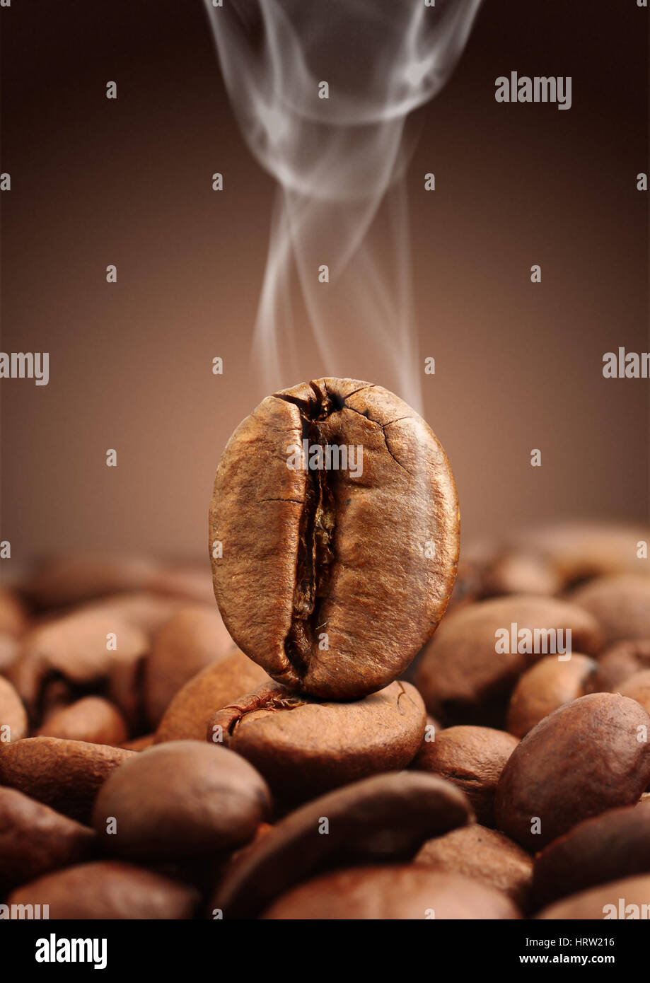 Closeup coffee bean with smoke on brown background Stock Photo - Alamy