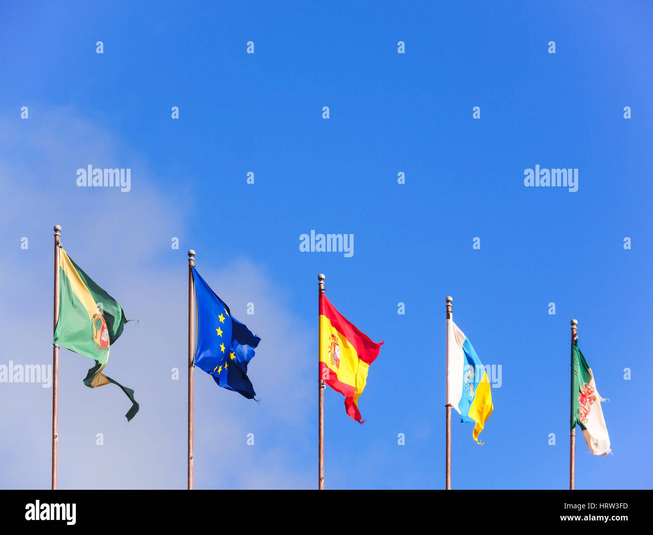 Five flags of different countries isolated on blue sky Stock Photo - Alamy