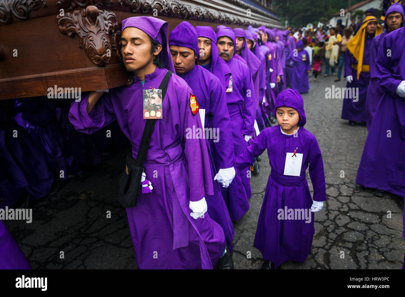 Antigua, Guatemala - April 16, 2014: Man wearing purple robes, carrying ...