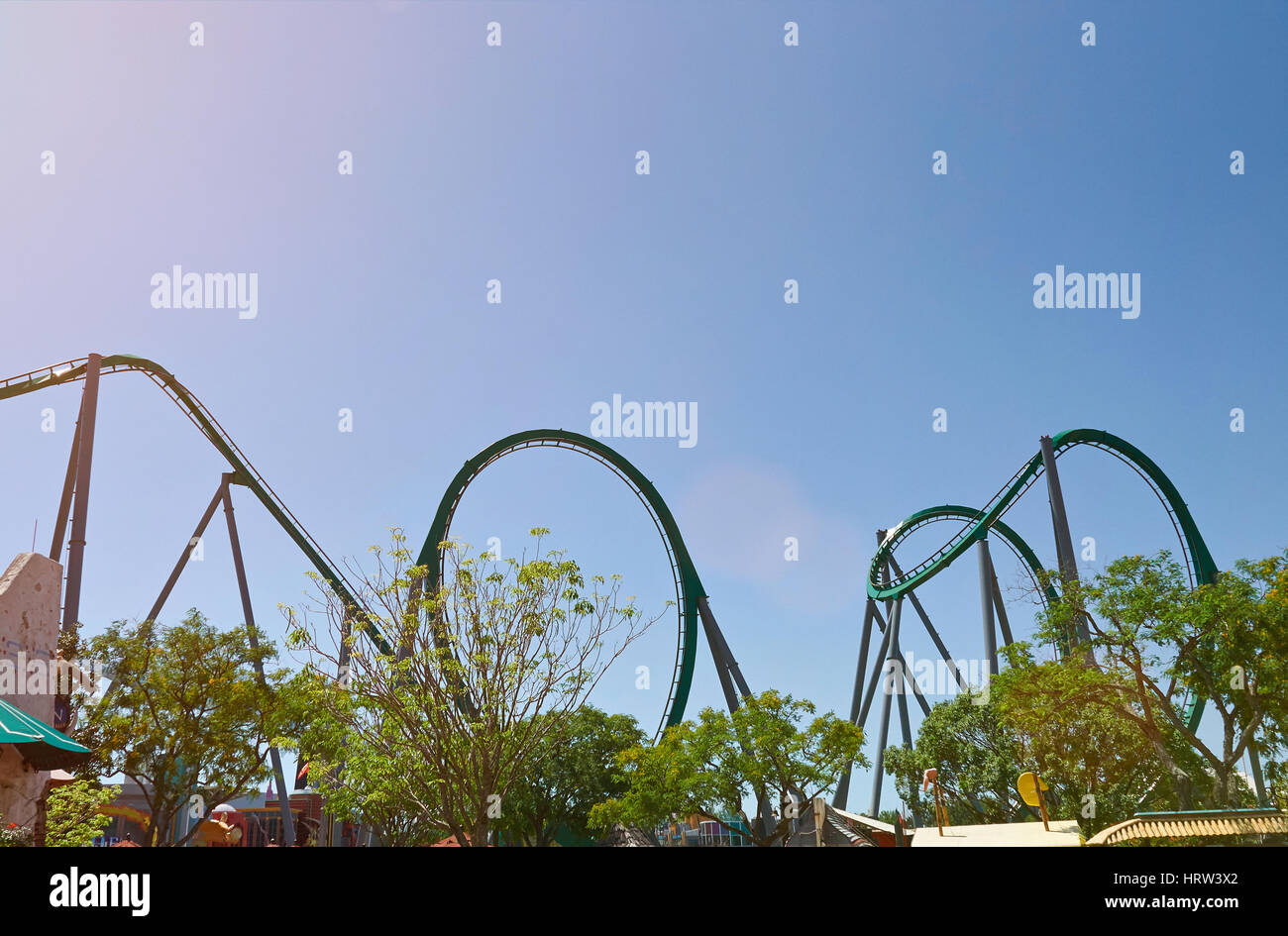 Roller coaster rail on sunny blue sky background. Metal rail for ...