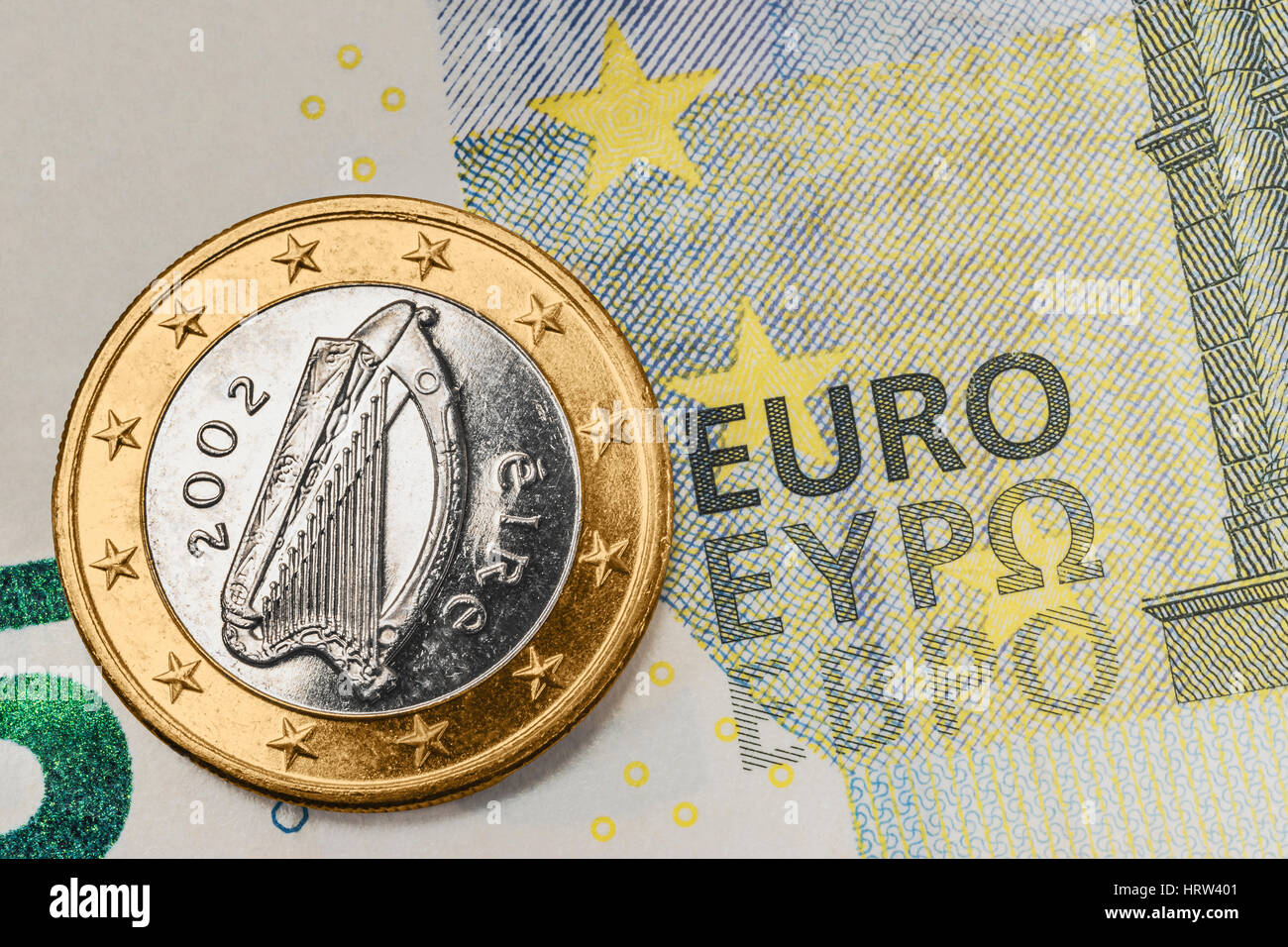 a 1 euro coin from Ireland on a 5 euro banknote Stock Photo - Alamy