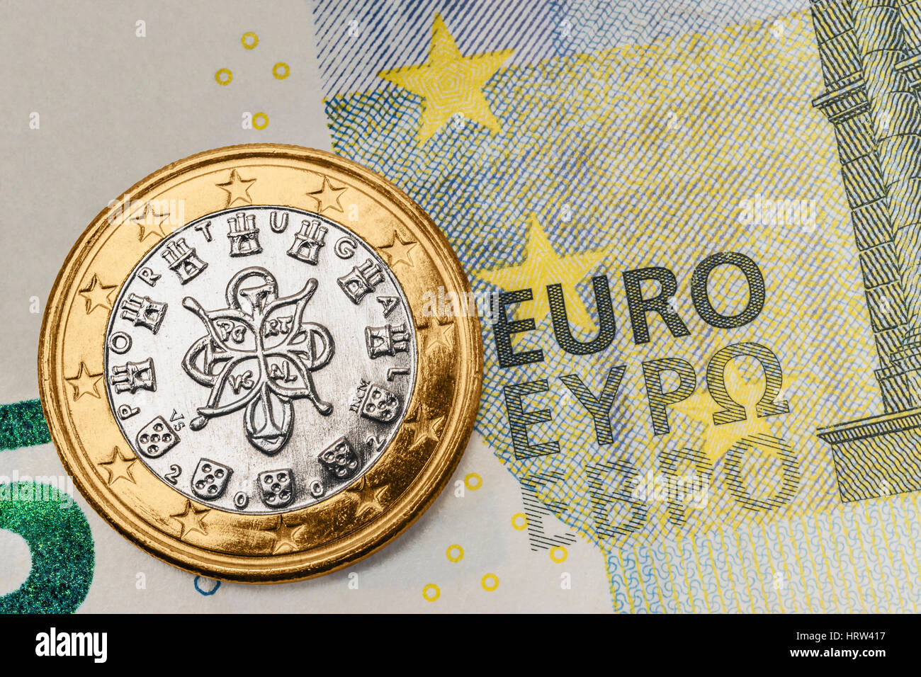 a 1 euro coin from Portugal on a 5 euro banknote Stock Photo - Alamy