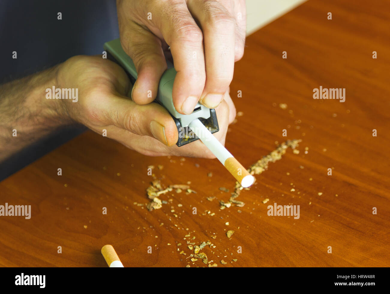 Man rolling cigarettes using fresh tobacco Stock Photo - Alamy