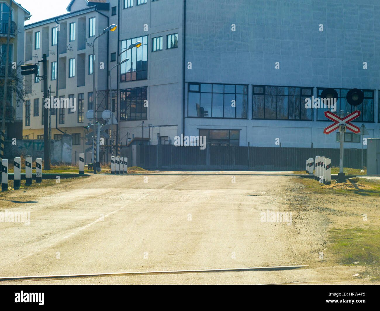 The closed railroad crossing in front of a train passing Stock Photo ...