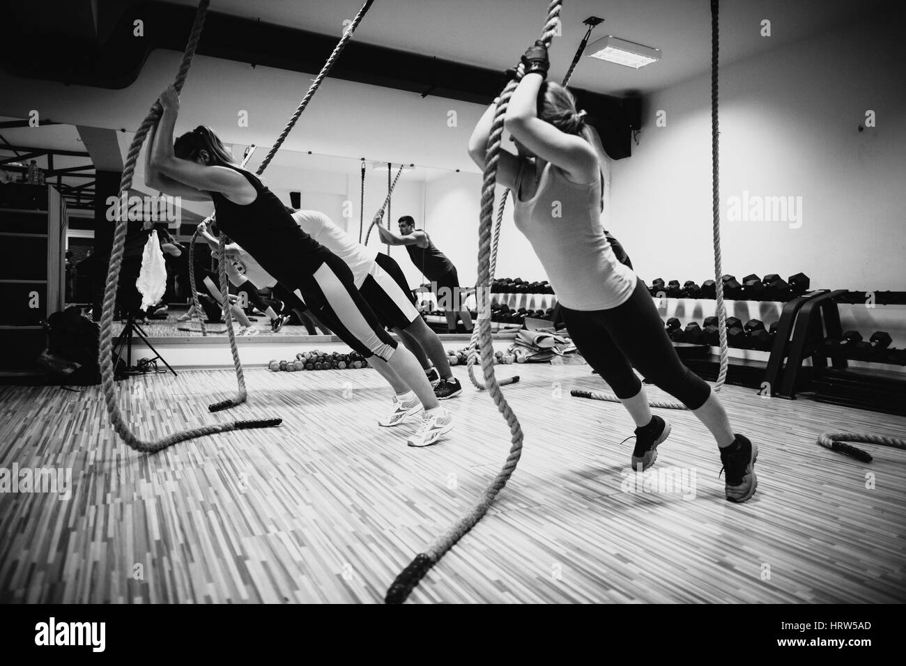 crossfit group training. Man and woman group training indoors. Black ...