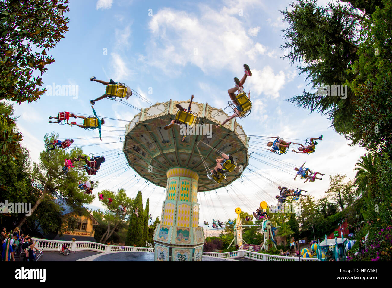 BARCELONA - SEP 5: People have fun at the carousel flying swing ride ...
