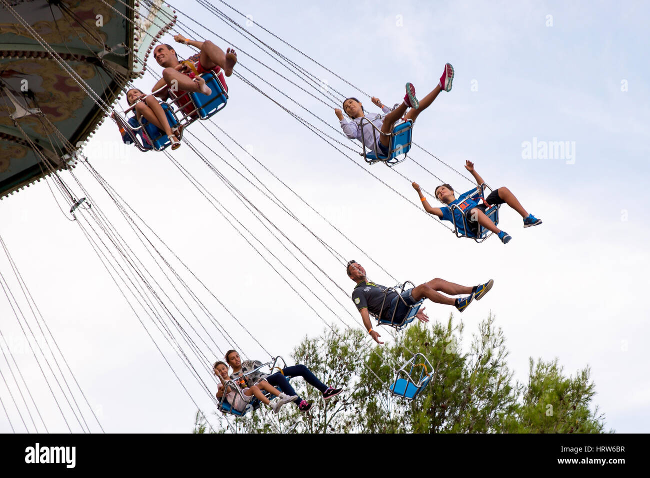 BARCELONA - SEP 5: People have fun at the carousel flying swing ride ...